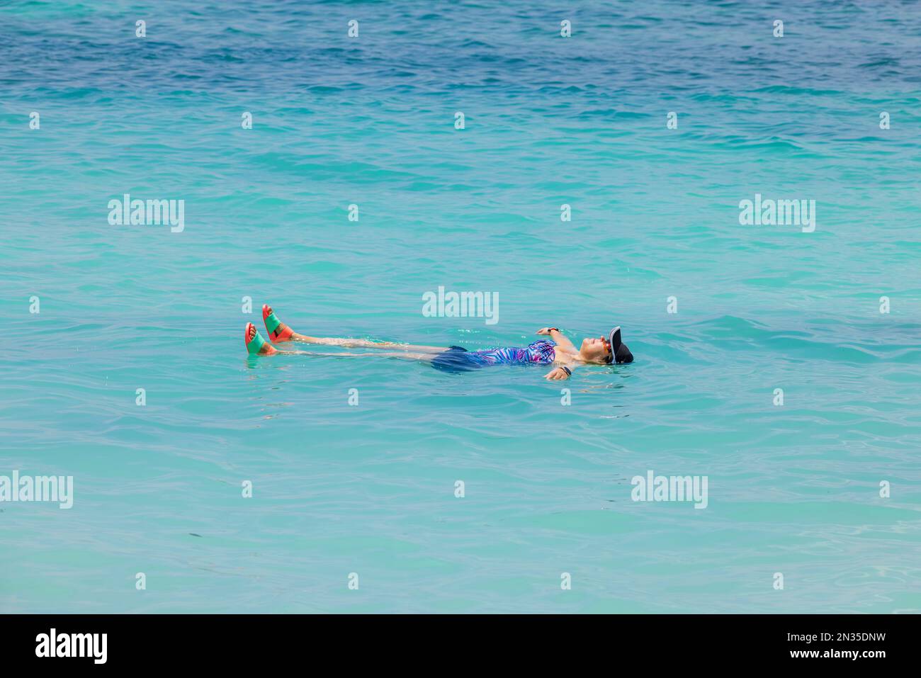 View of woman laying on water surface. Aruba, Atlantic Ocean Stock ...