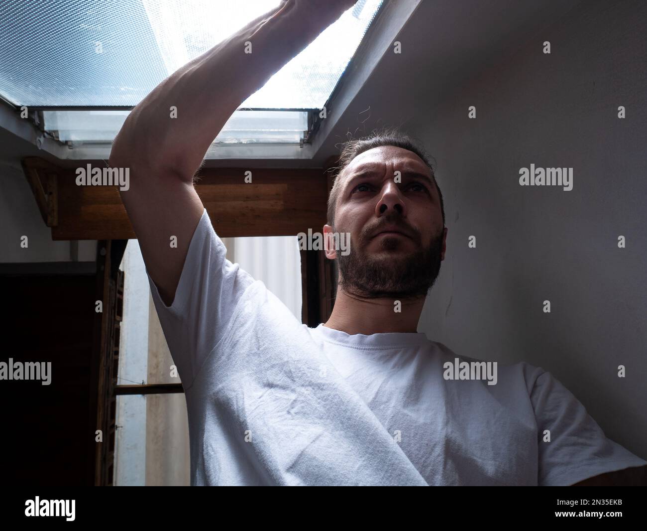Young White Man Applies Putty on a White Wall to Fill Cracks Stock ...