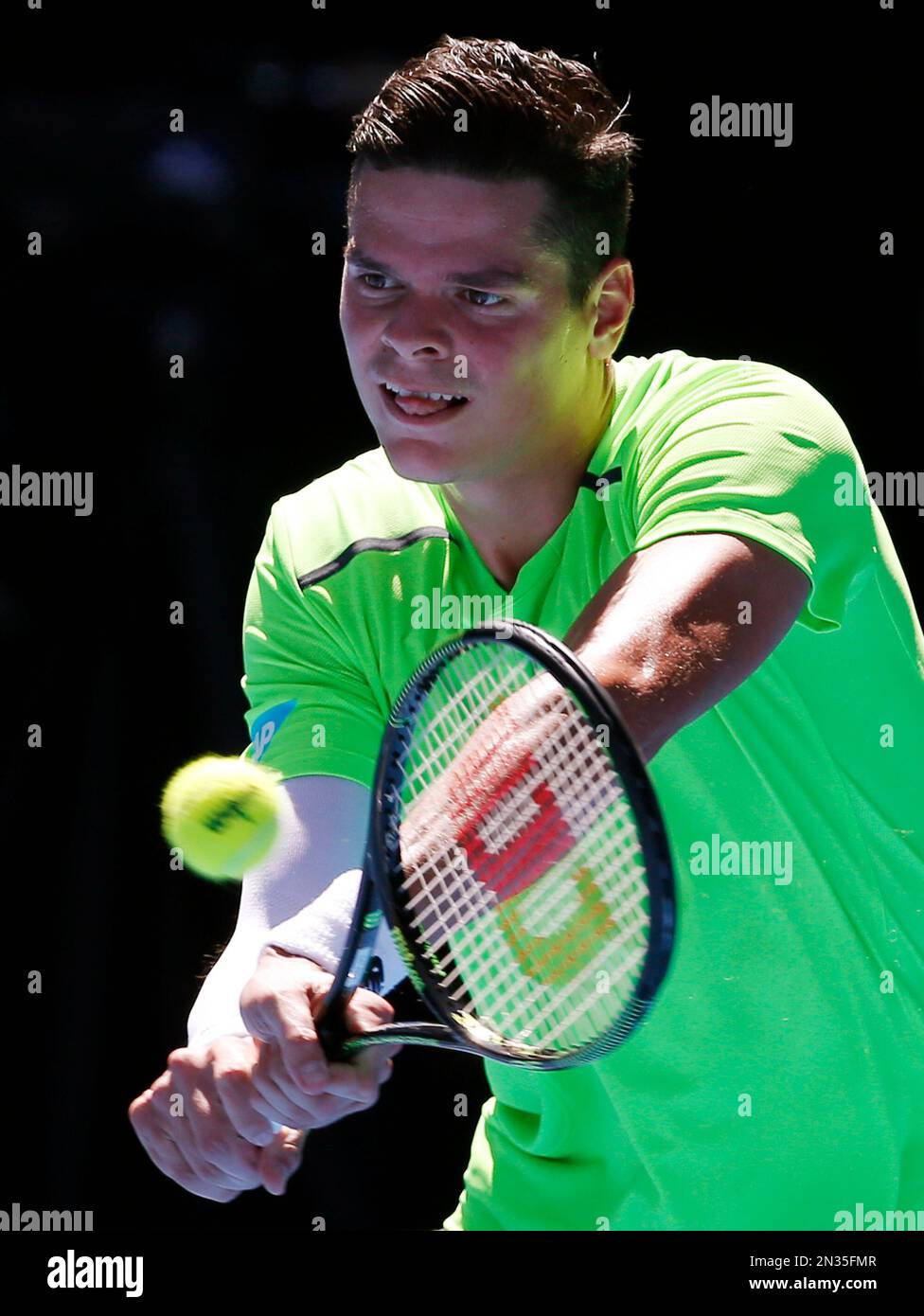 Milos Raonic of Canada makes a backhand return to Benjamin Becker of ...