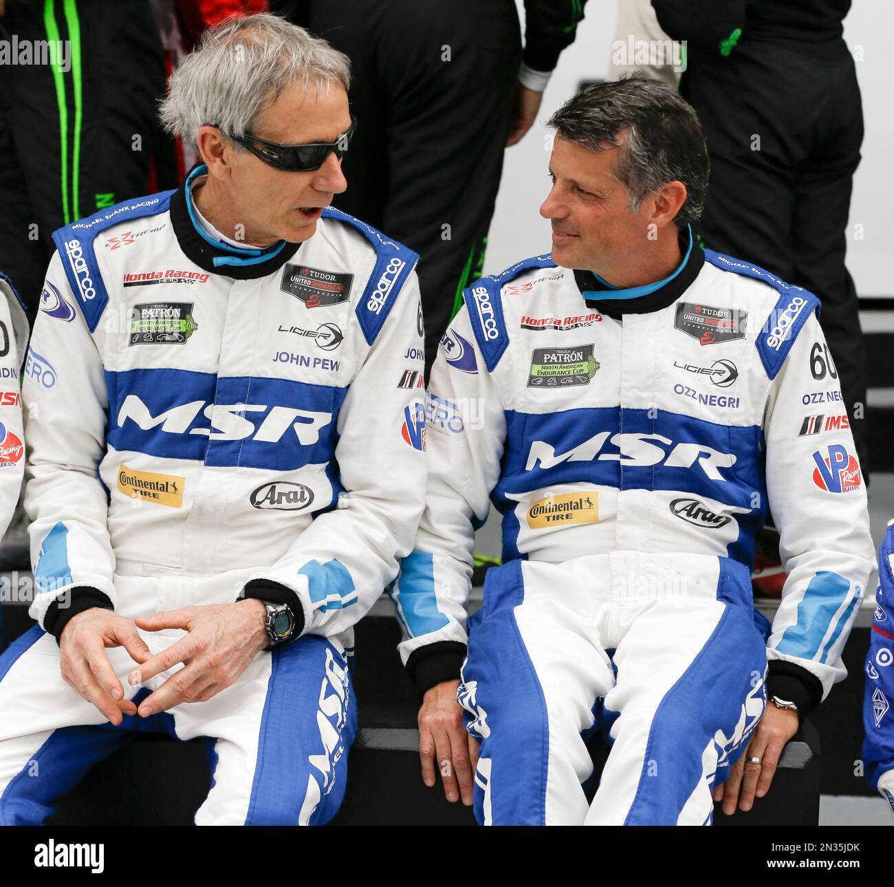 Co-drivers John Pew, left, and Oswaldo Negri, Jr., of Brazil, talk ...