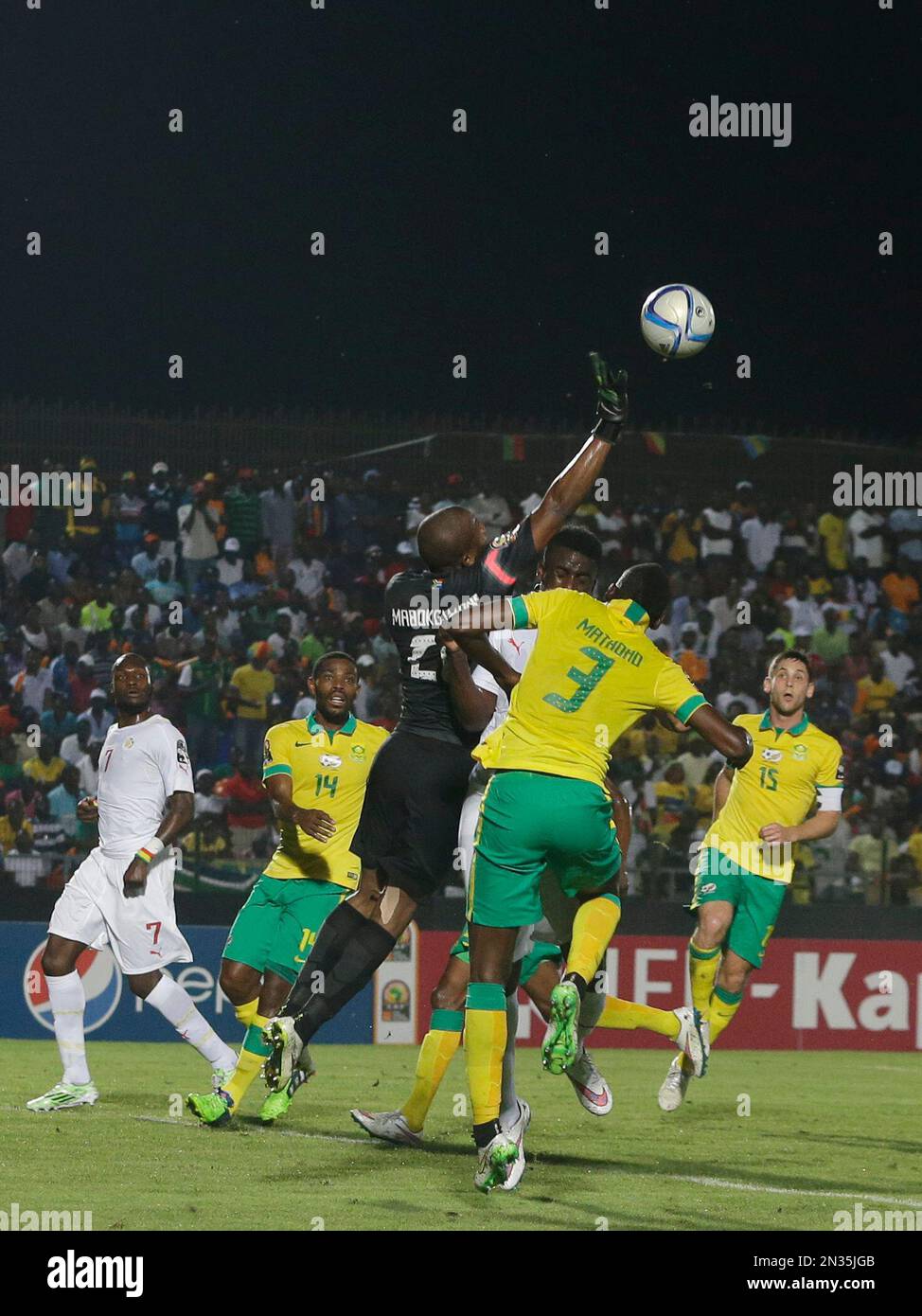 South Africa's goalkeeper Jackson Mabokgwane, center, clears the ball ...