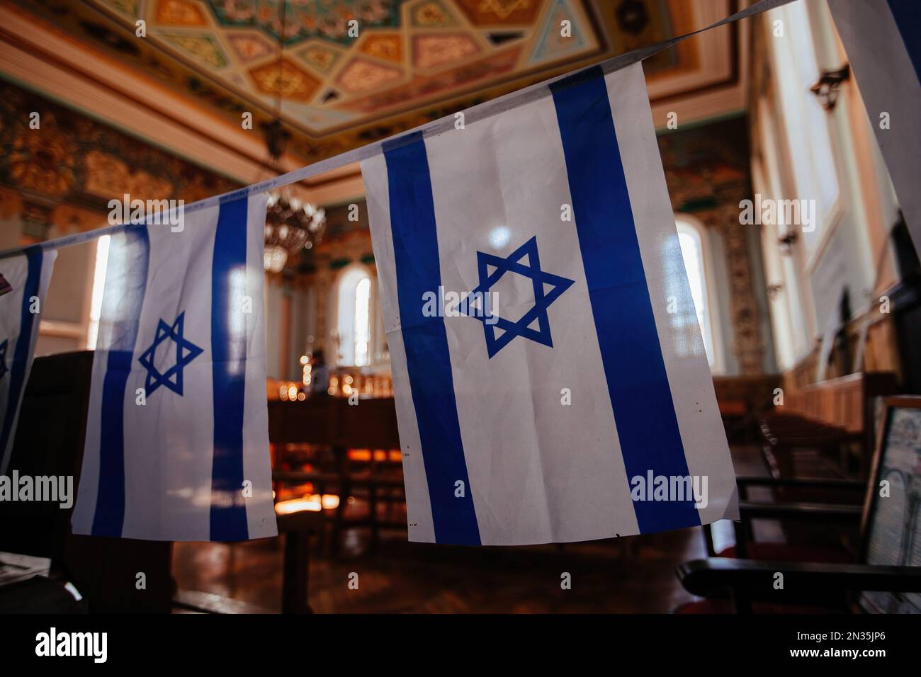 Flags of Israel inside the synagogue Stock Photo - Alamy