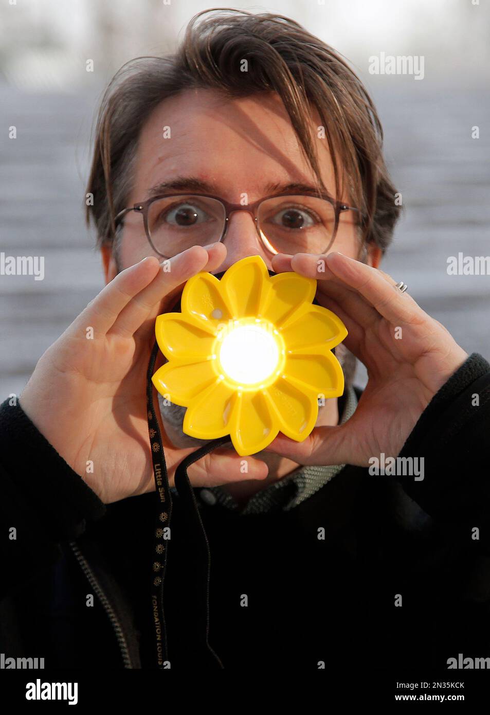 Danish artist Olafur Eliasson poses with his "Little Sun" solar lamp as ...