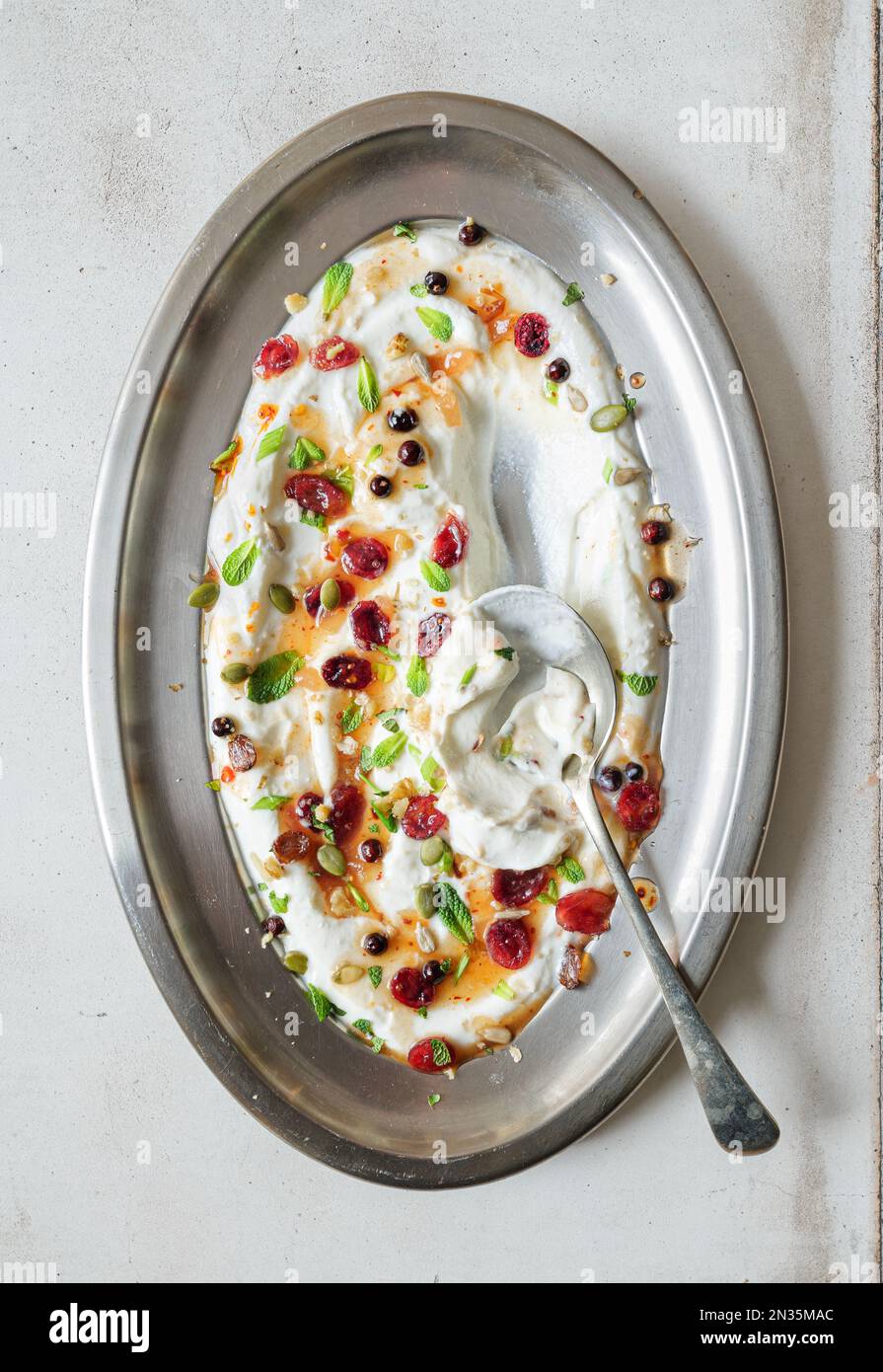 Greek Yogurt dish, dressed with berries, nuts and spearmint Stock Photo ...