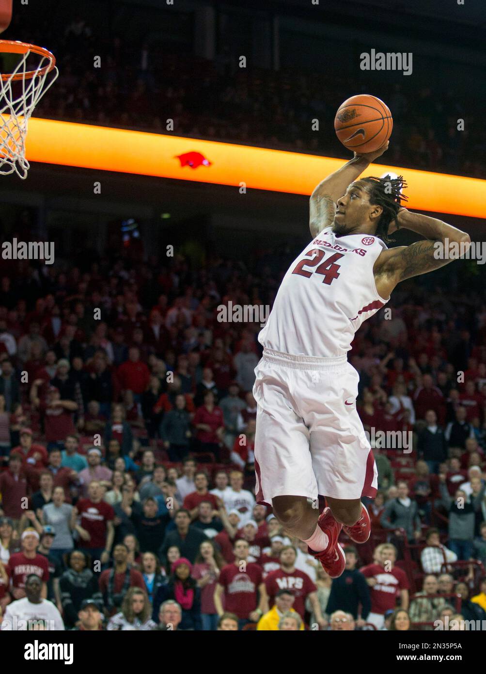 Arkansas guard Michael Qualls, right, leaps for a one-handed dunk ...