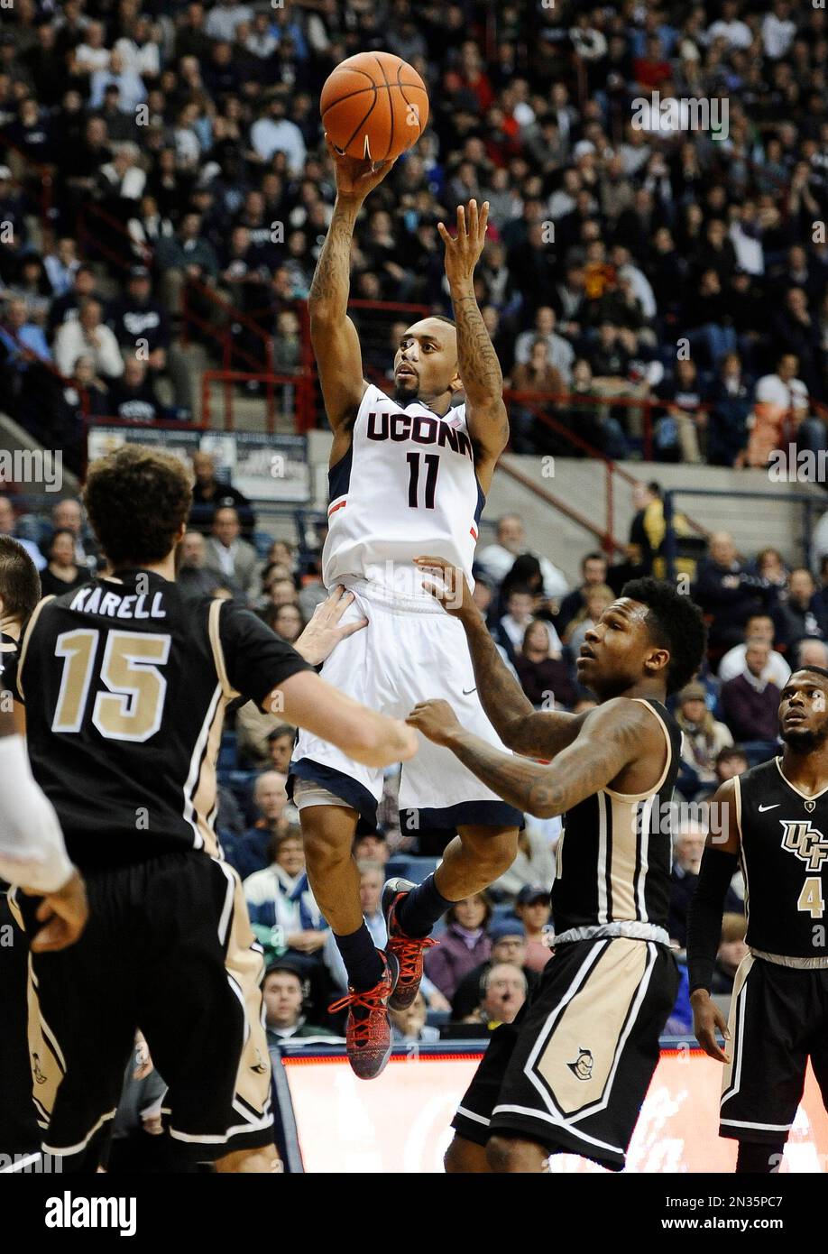 Connecticut’s Ryan Boatright shoots over UCF’s Dylan Karell, left, and ...