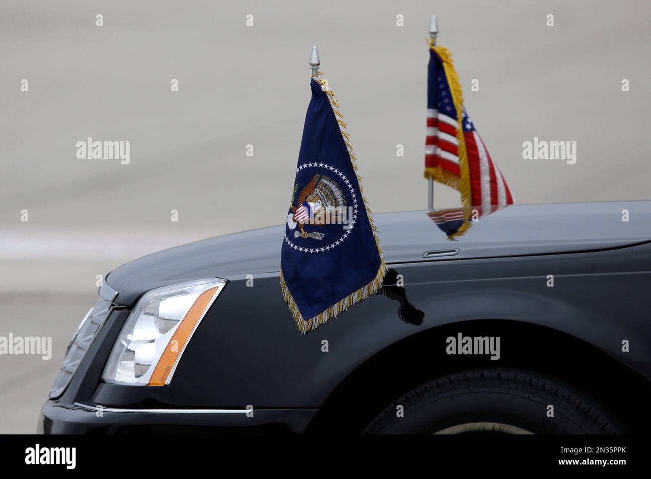 Finder flags on the presidential limousine before Air Force One departs ...