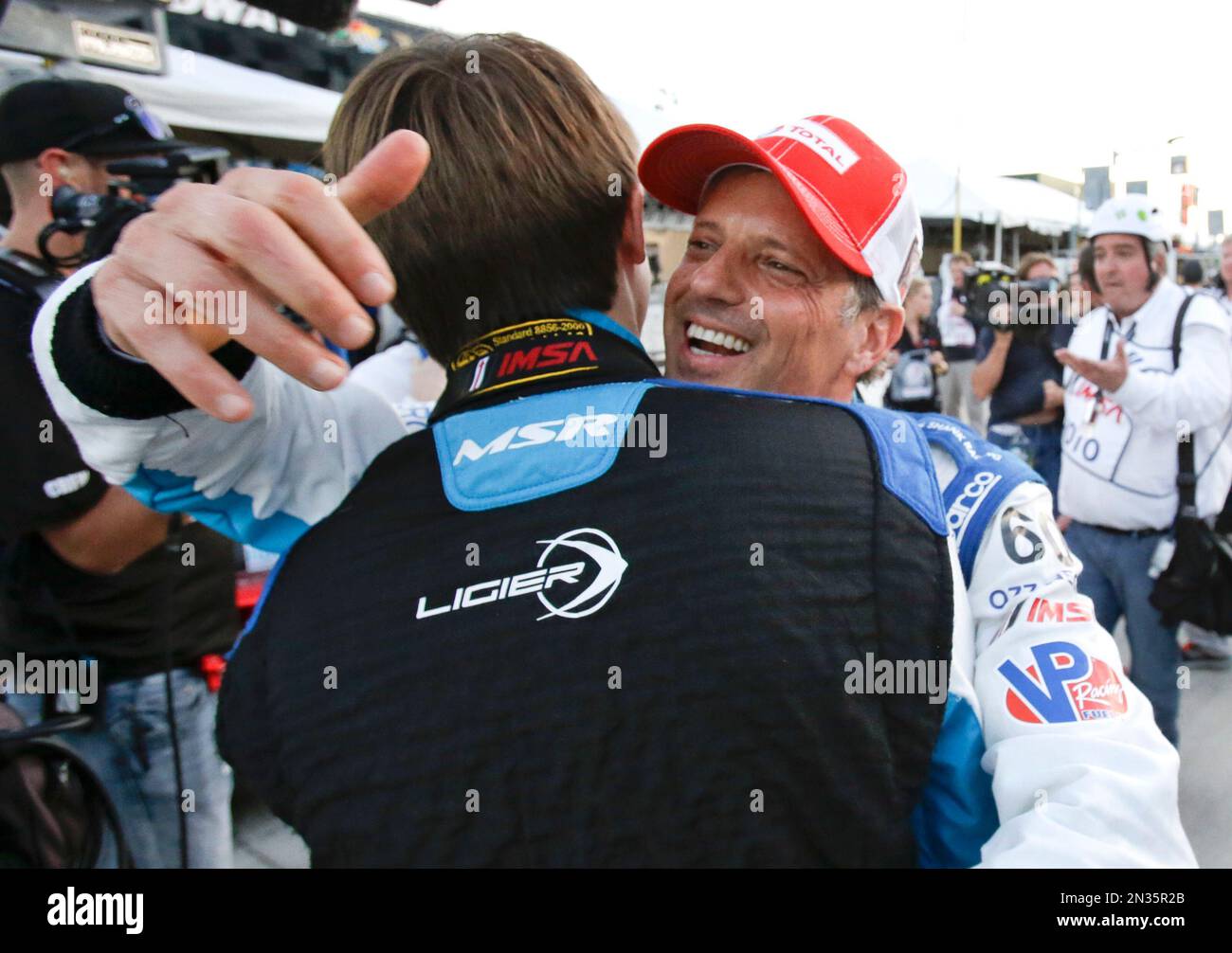 Oswaldo Negri Jr., right, of Brazil, celebrates with co-driver Matt ...
