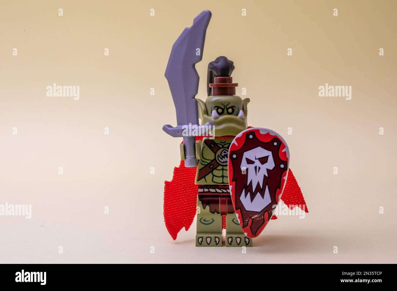 A small green orc Lego figurine with a sword and a shield isolated on a ...