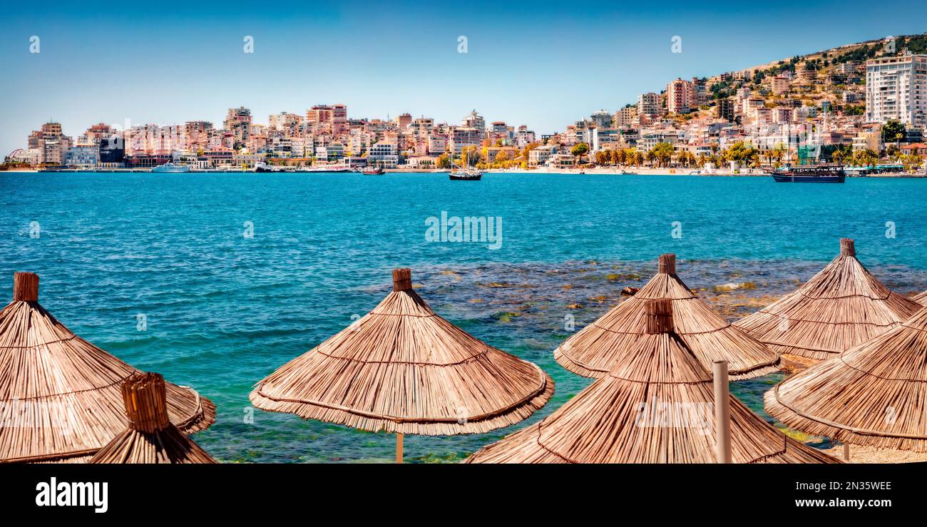 Public beach in Saranda. Colorful summer cityscape of Sarande is a port ...