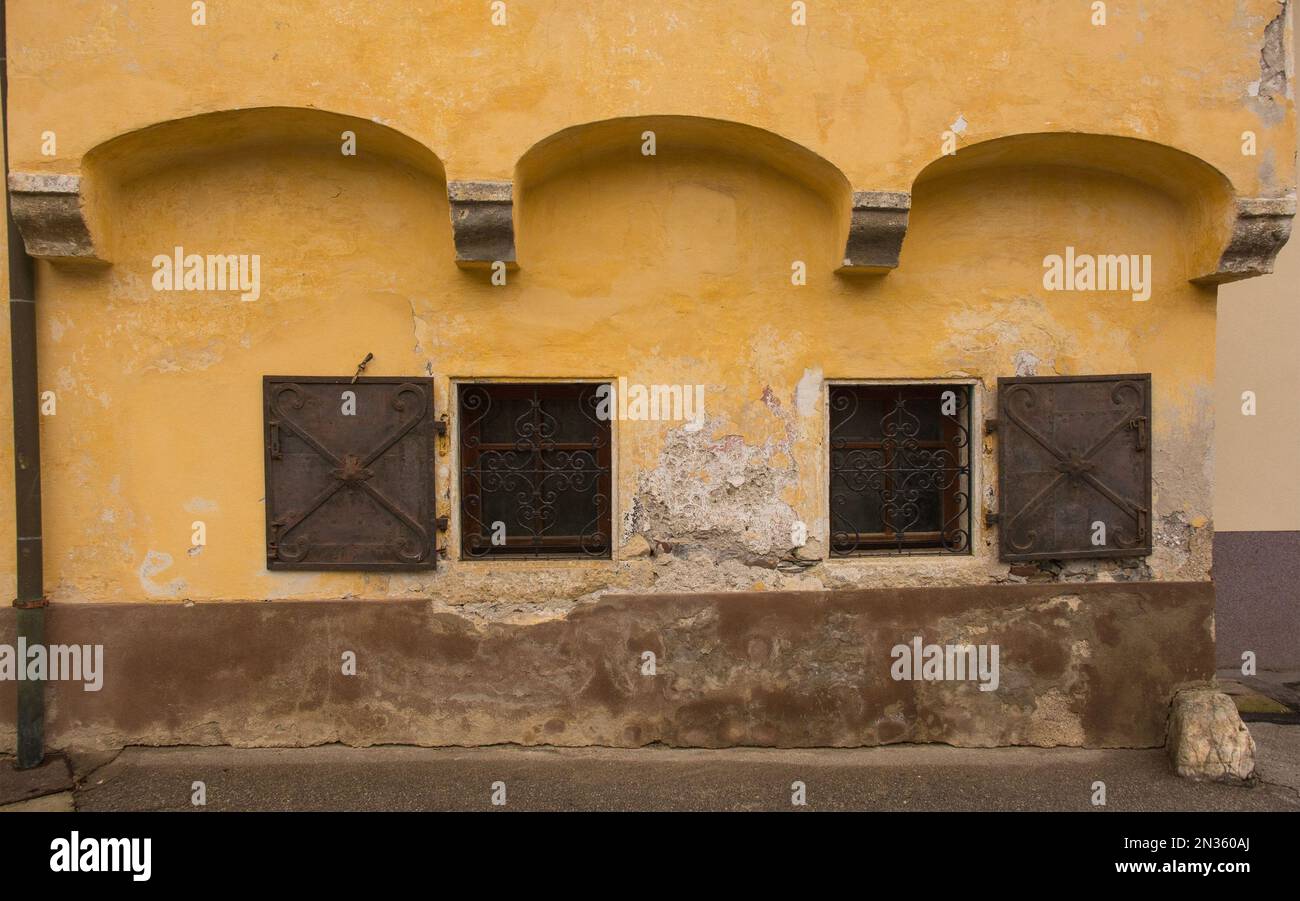 Window with traditional metal shutters in an historic building Skofja ...
