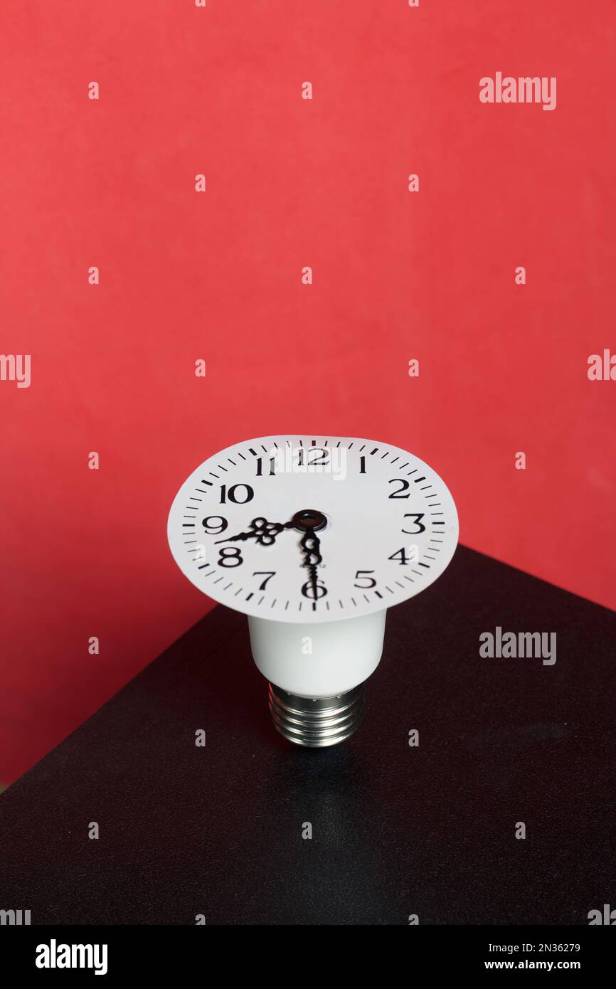 Light bulb with clock face. arrows at 20:30. Global ecology ...