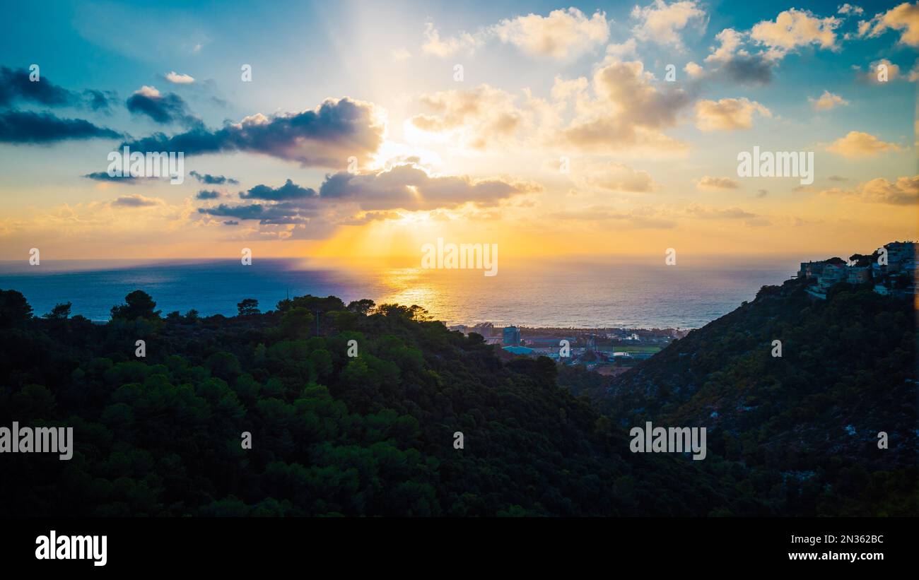 An aerial breathtaking view of colorful sunset clouds over coastal ...