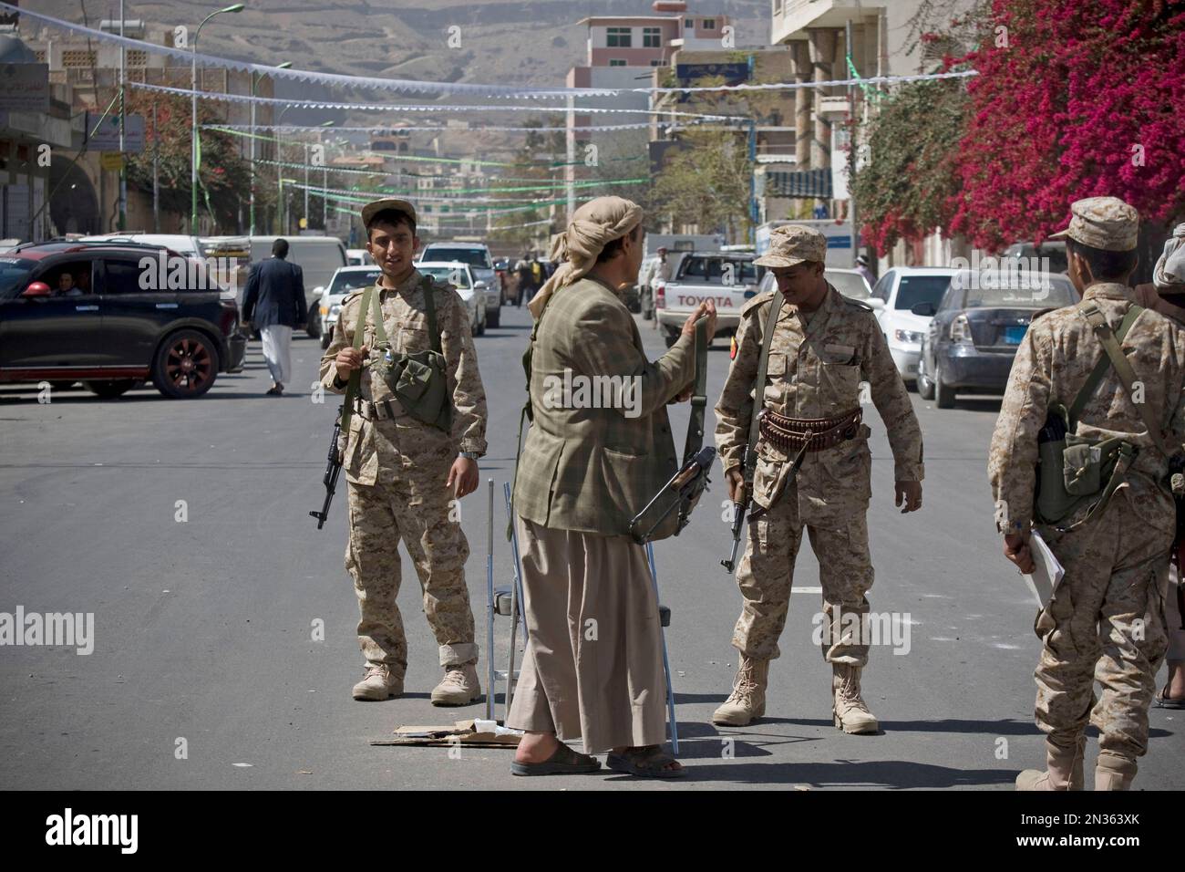 Houthi Shiite Yemeni wearing army uniforms stand guard on a street ...