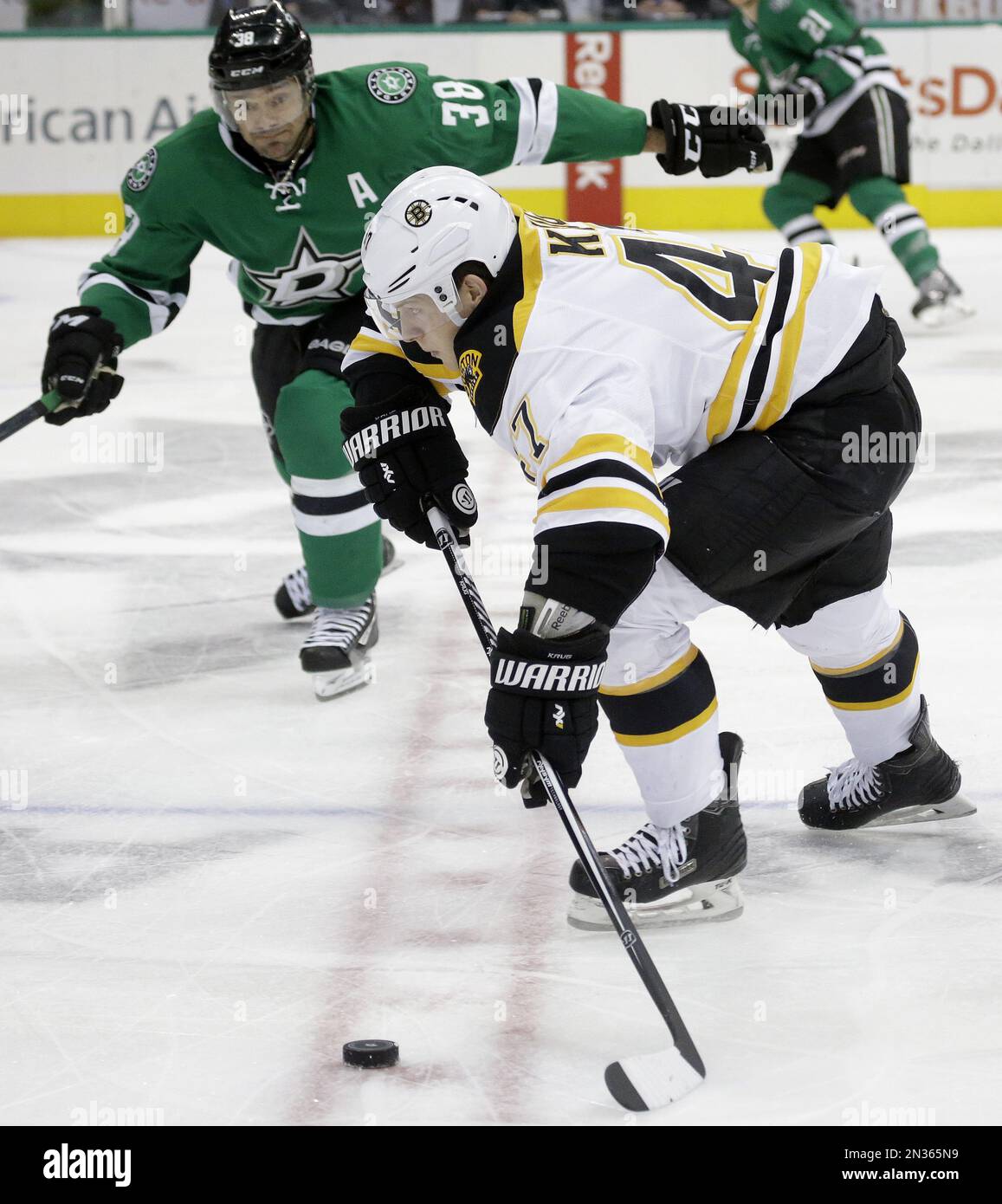 Boston Bruins defenseman Torey Krug (47) skates with the puck against ...