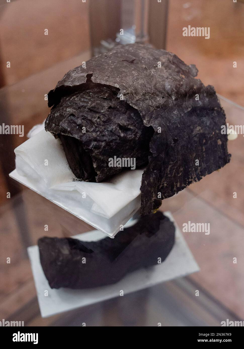 An ancient scroll, completely covered in blazing-hot volcanic material ...