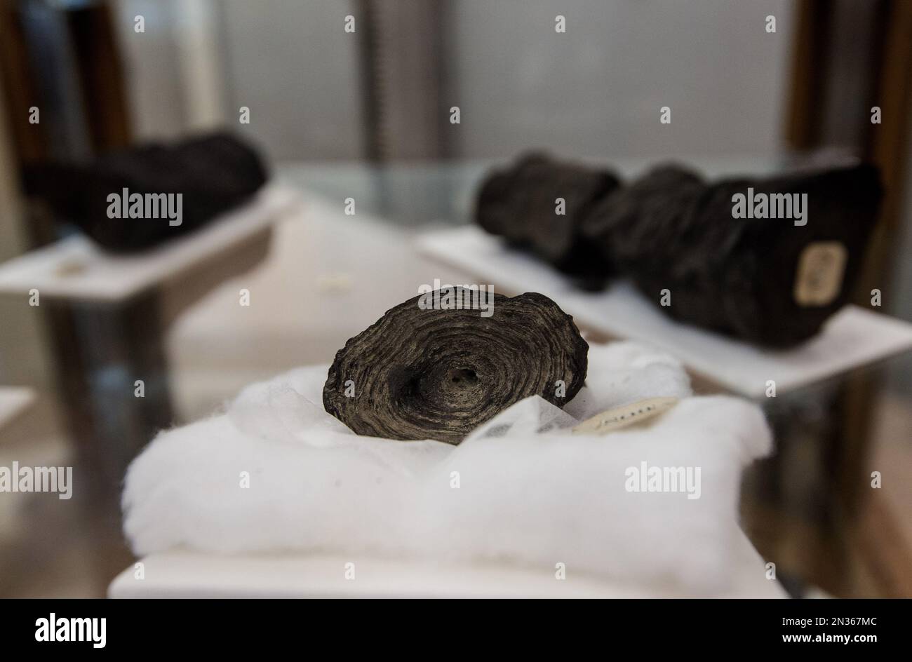 Ancient scrolls, completely covered in blazing-hot volcanic material ...