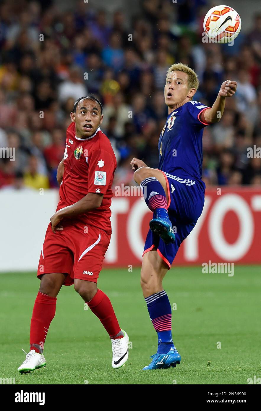 Jordan's Monther Abu Amara, left, and Japan’s Keisuke Honda, right ...