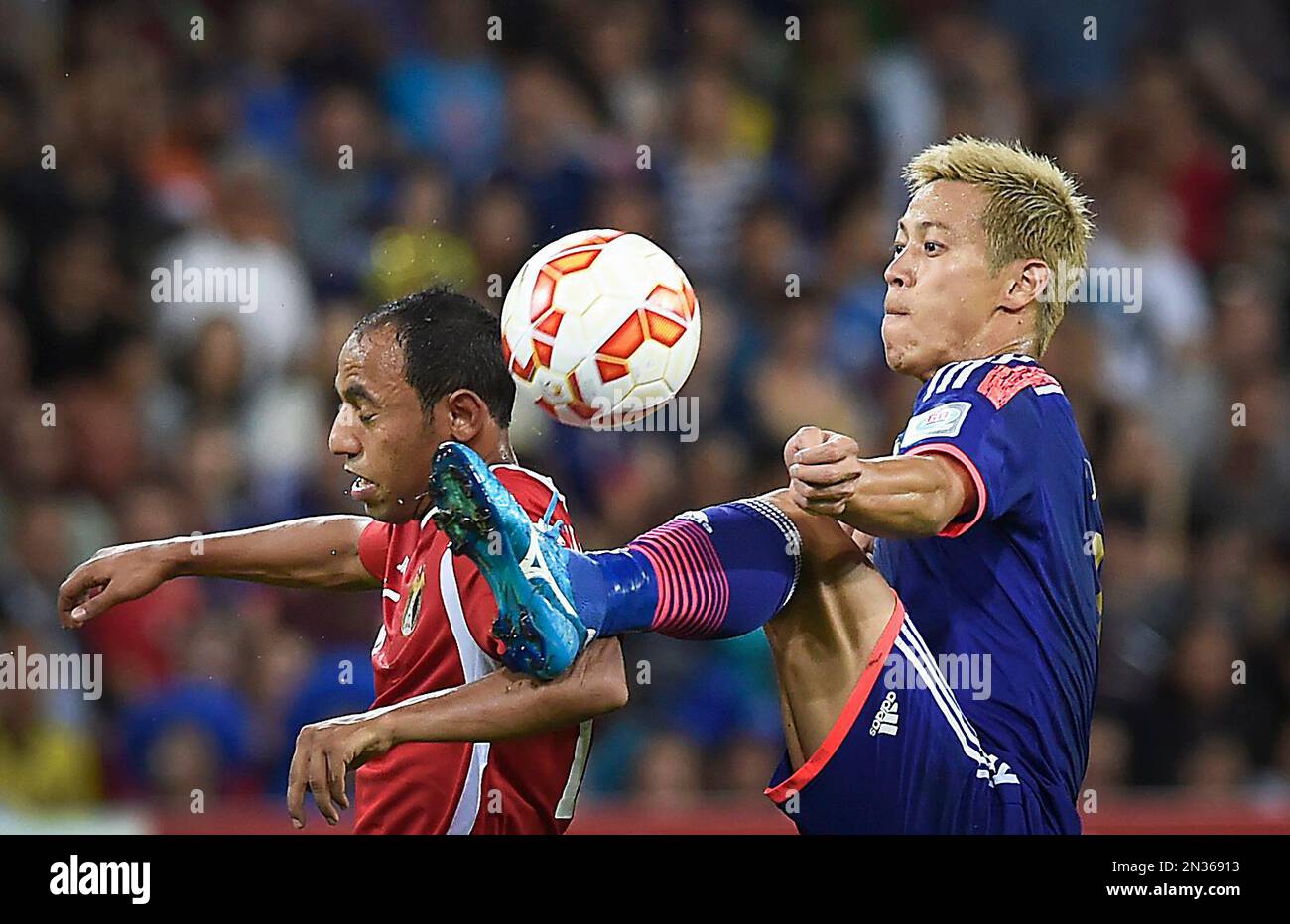Jordan's Monther Abu Amara, left, and Japan’s Keisuke Honda, right ...