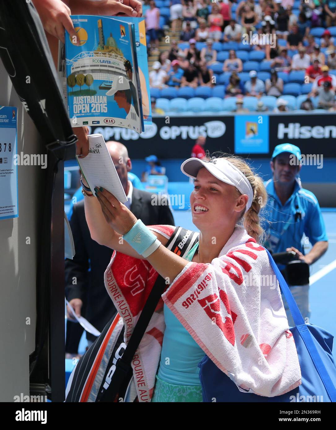 Caroline Wozniacki of Denmark signs autographs as she leaves the court ...
