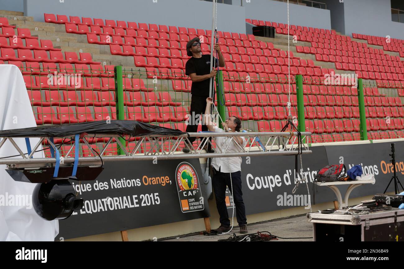 Engineers install a camera at the Estadio De Malabo, ahead of group D ...