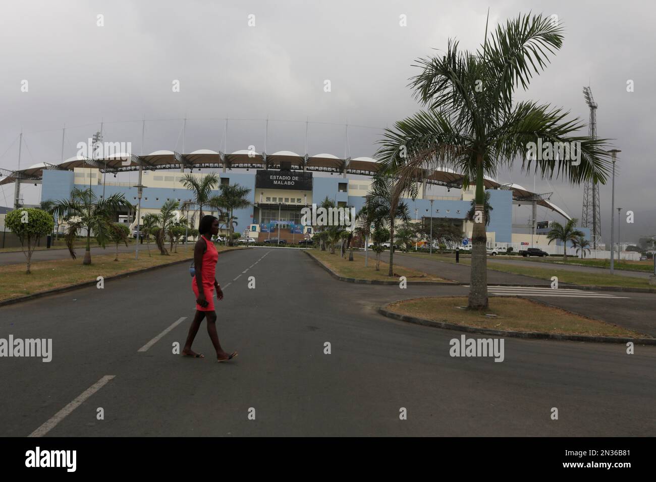 An unidentified woman walks past Estadio De Malabo, the group D venue ...