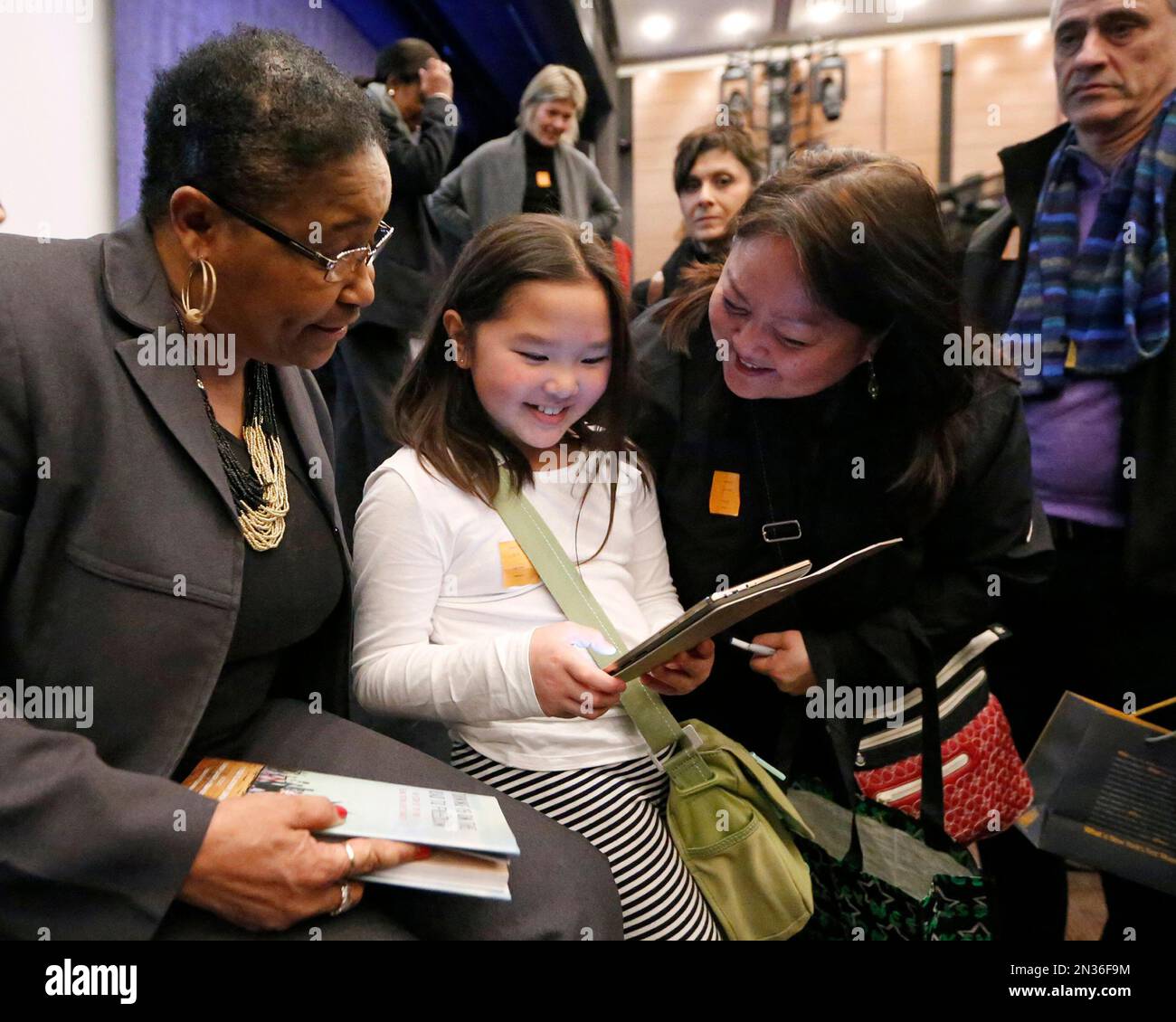 Lynda Blackmon Lowery, left, shares a moment with a young girl and her ...