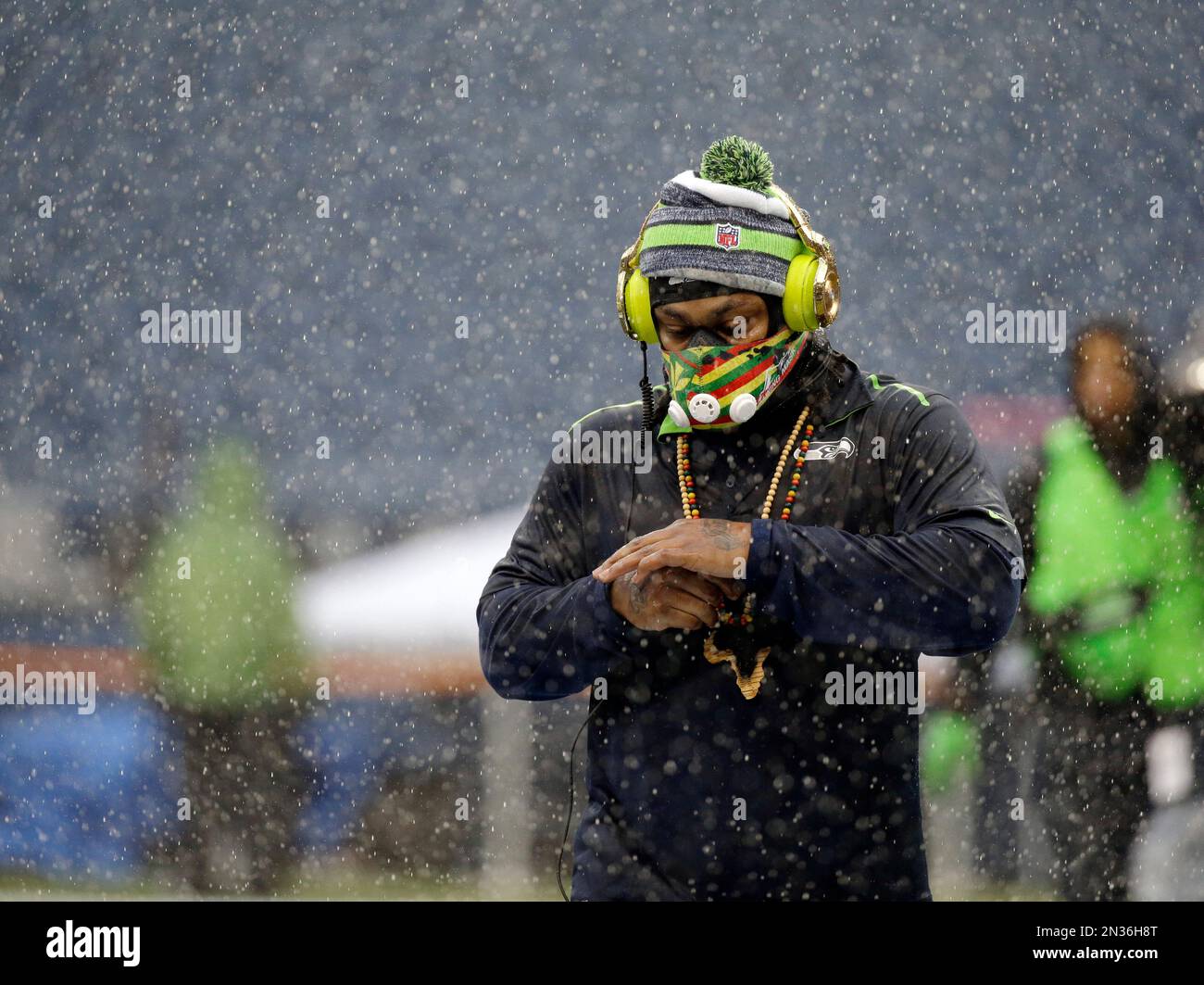 Seattle Seahawks' Marshawn Lynch warms up in the rain before the NFL ...
