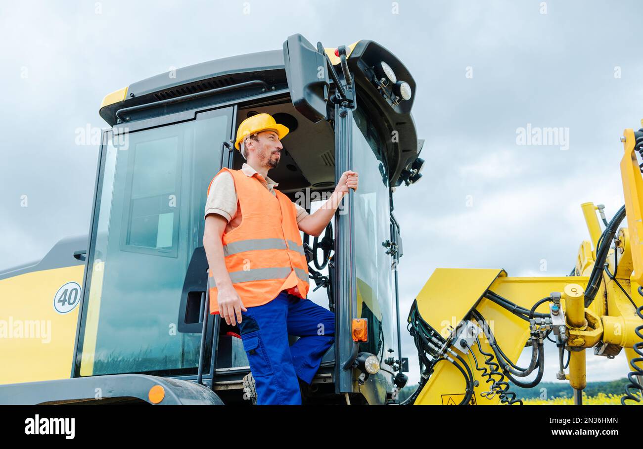 Construction worker on excavator planning the work to be done Stock ...