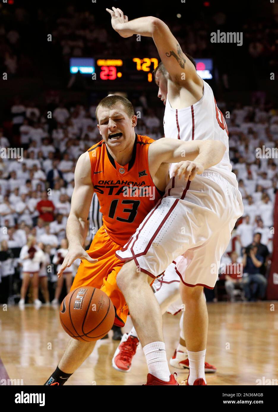 Oklahoma State guard Phil Forte (13) drives around Oklahoma forward ...