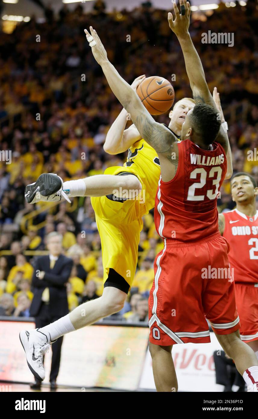 Iowa forward Aaron White, left, is fouled by Ohio State center Amir ...