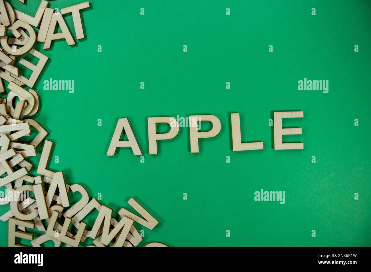 APPLE fruit in wooden English language capital letters spilling from a ...