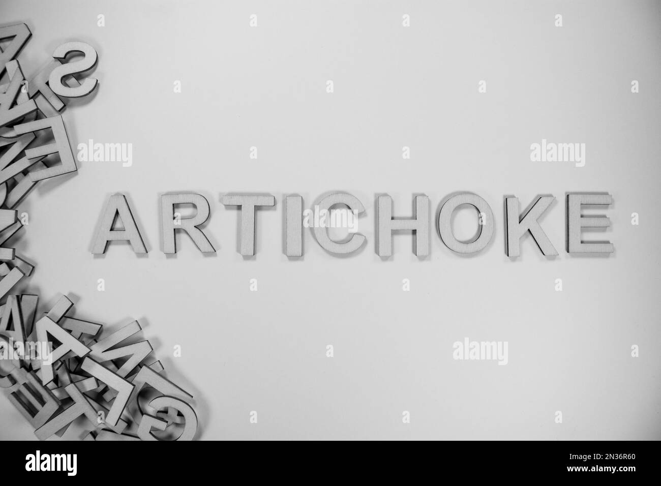 ARTICHOKE in wooden English words language capital letters spilling ...