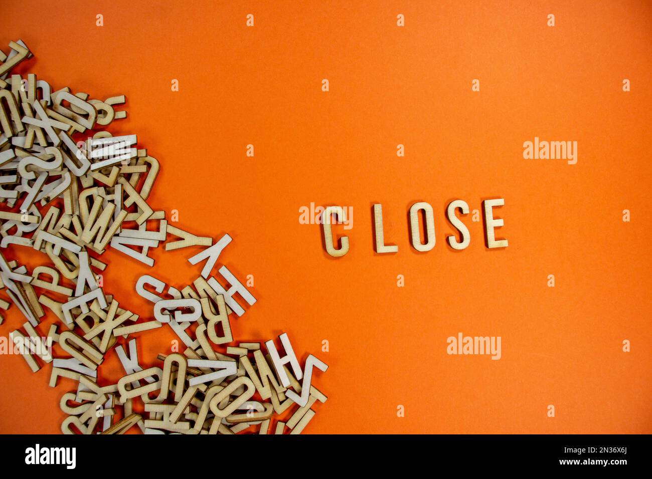 CLOSE in wooden English language capital letters spilling from a pile ... CLOSE in wooden English language capital letters spilling from a pile ...
