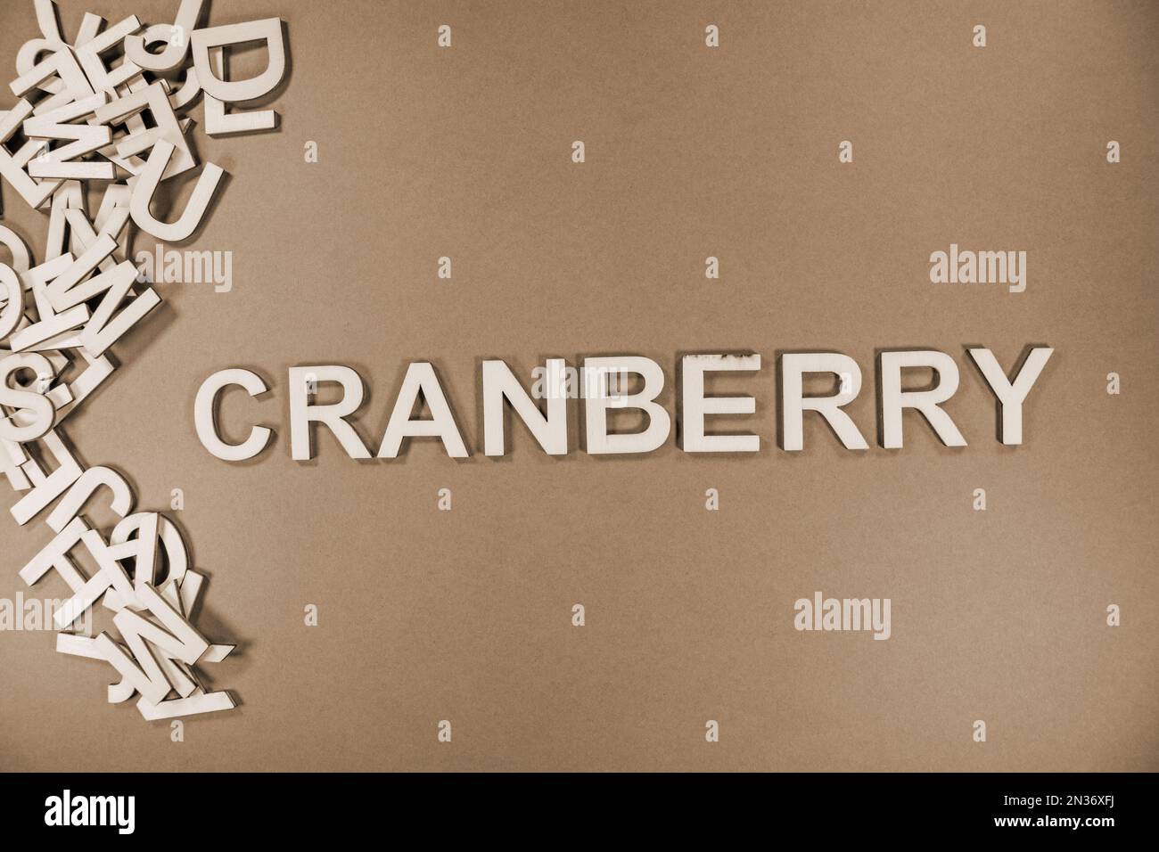 CRANBERRY fruit in wooden English language capital letters spilling ...