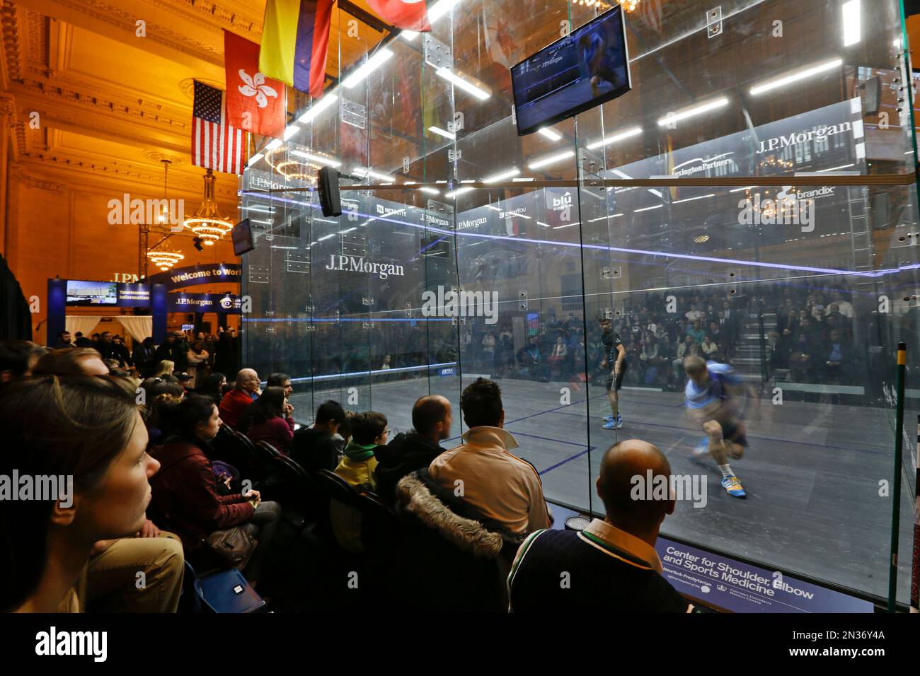 Fans watch Alan Clyne, of Scotland, right, return a shot to Saurav ...