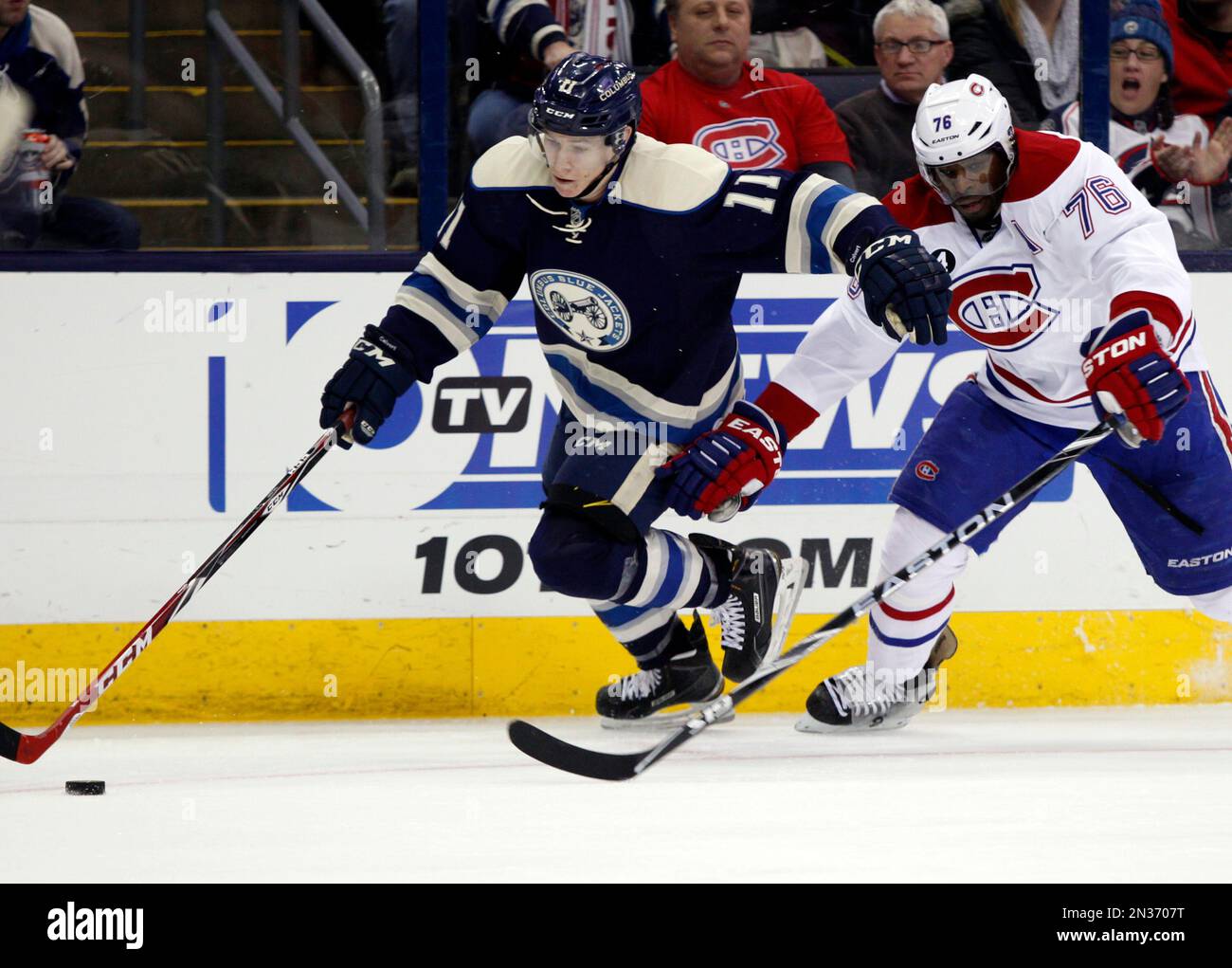 Columbus Blue Jackets' Matt Calvert, left, controls the puck against ...