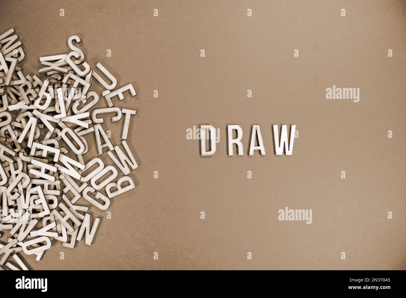 DRAW in wooden English language capital letters spilling from a pile of ...
