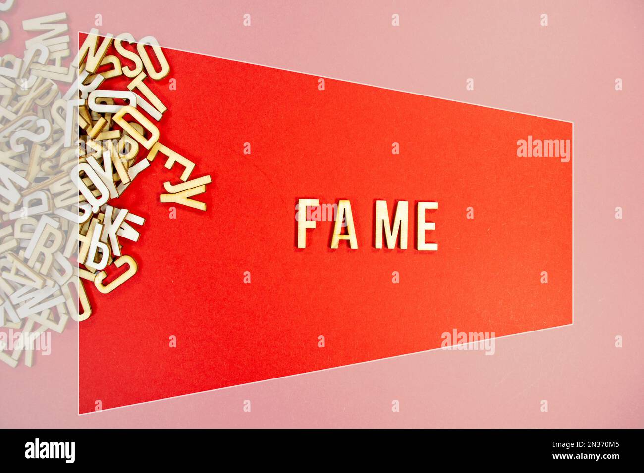 FAME in wooden English language capital letters spilling from a pile of ... FAME in wooden English language capital letters spilling from a pile of ...
