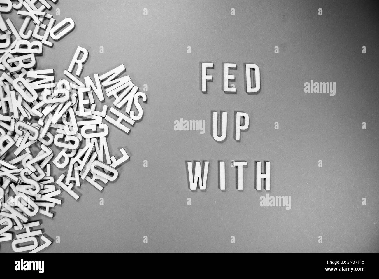 FED UP WITH in wooden English language capital letters spilling from a ...