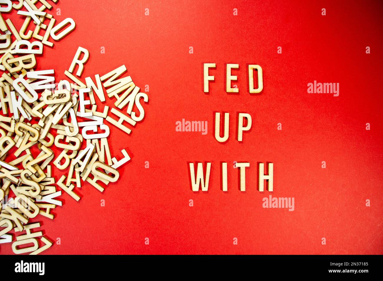 FED UP WITH in wooden English language capital letters spilling from a ...