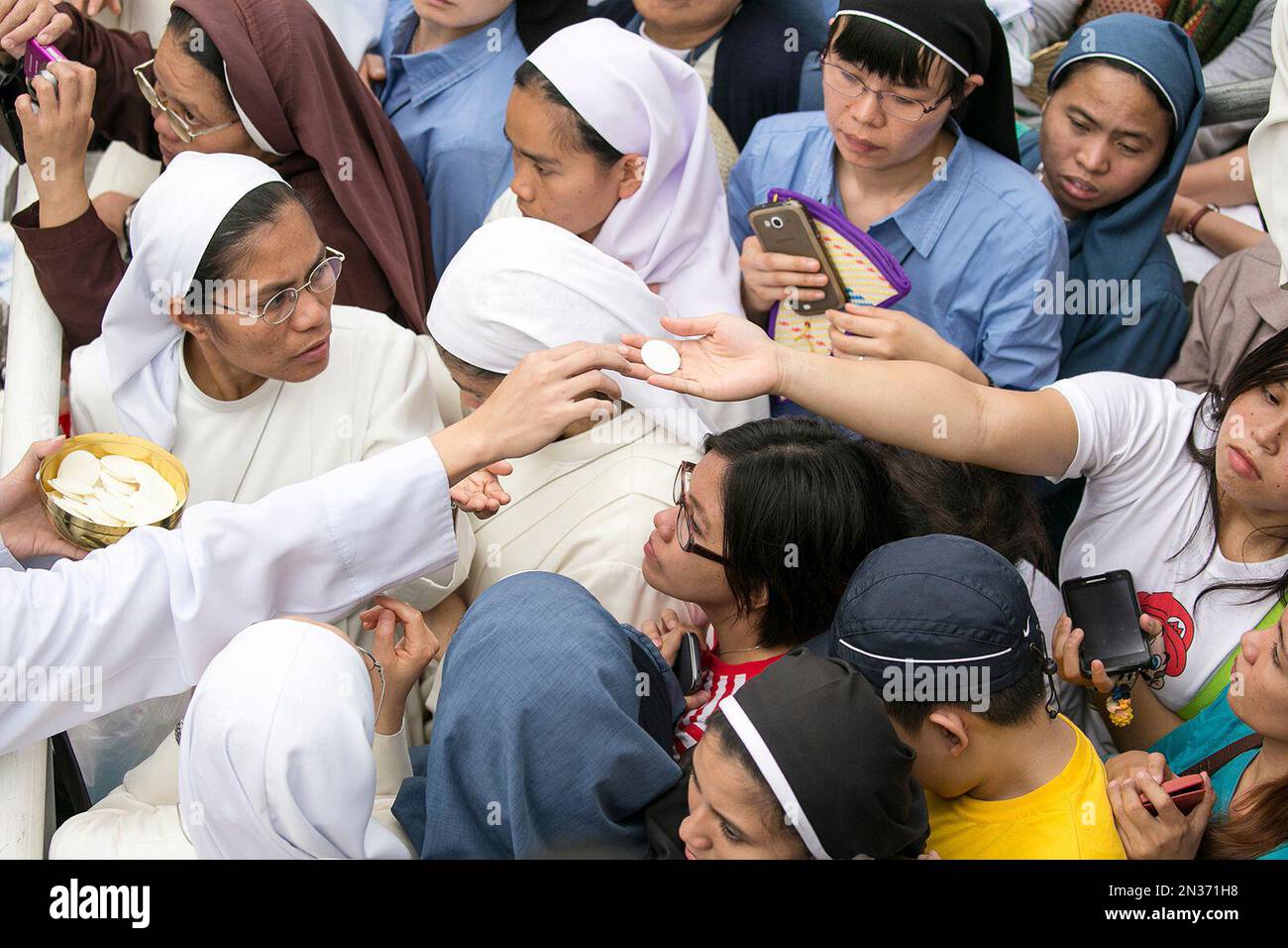 Filipino faithful receive communion as they attend a mass celebrated by ...