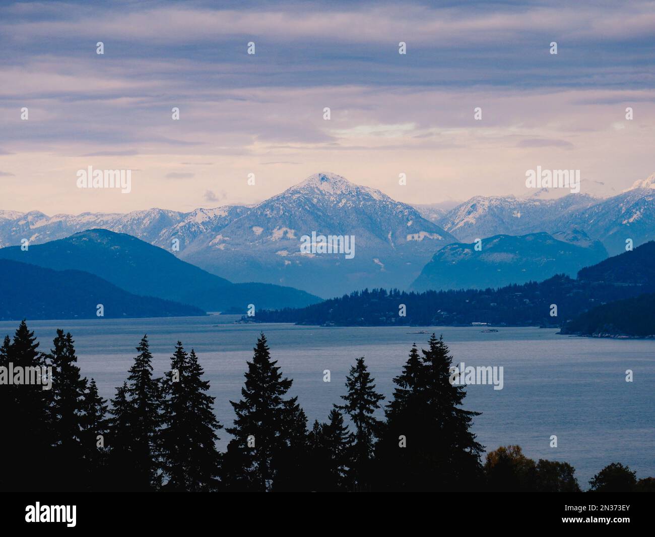 Aerial view of a lake with snowcap mountains in the background under ...