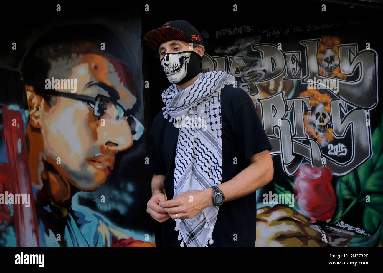 Local muralist Eric Norberg, wearing his Day of the Dead mask on Thurs ...