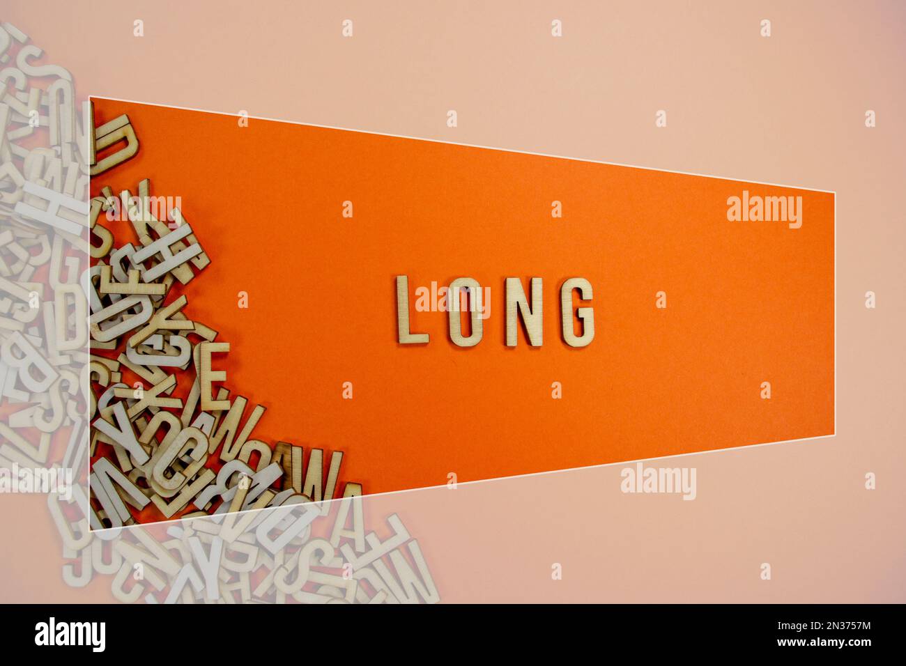 LONG in wooden English language capital letters spilling from a pile of ...