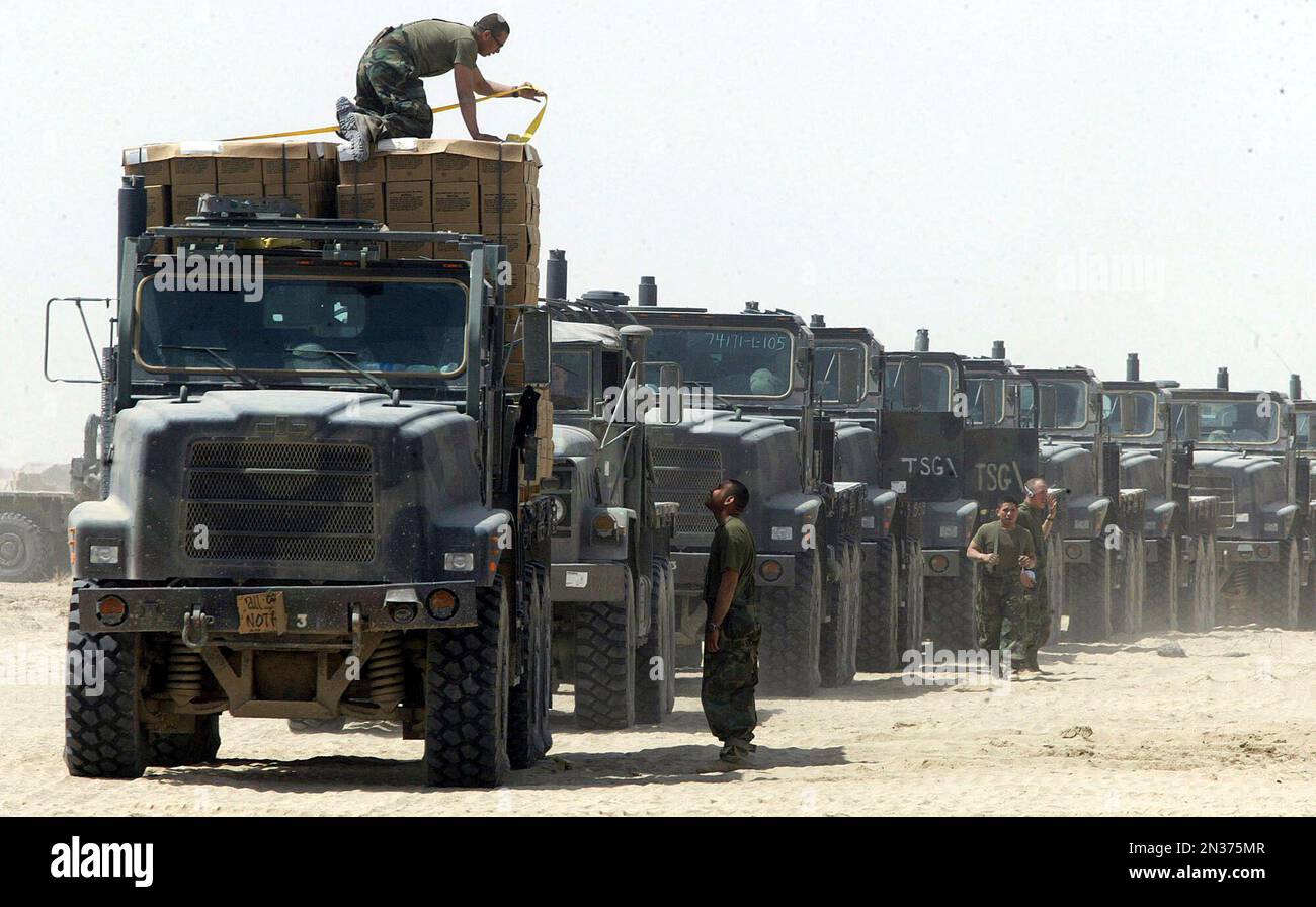 IRAQ3-C-29MAR03-MT-MAC Marine vehicles being loaded to re-supply troops ...