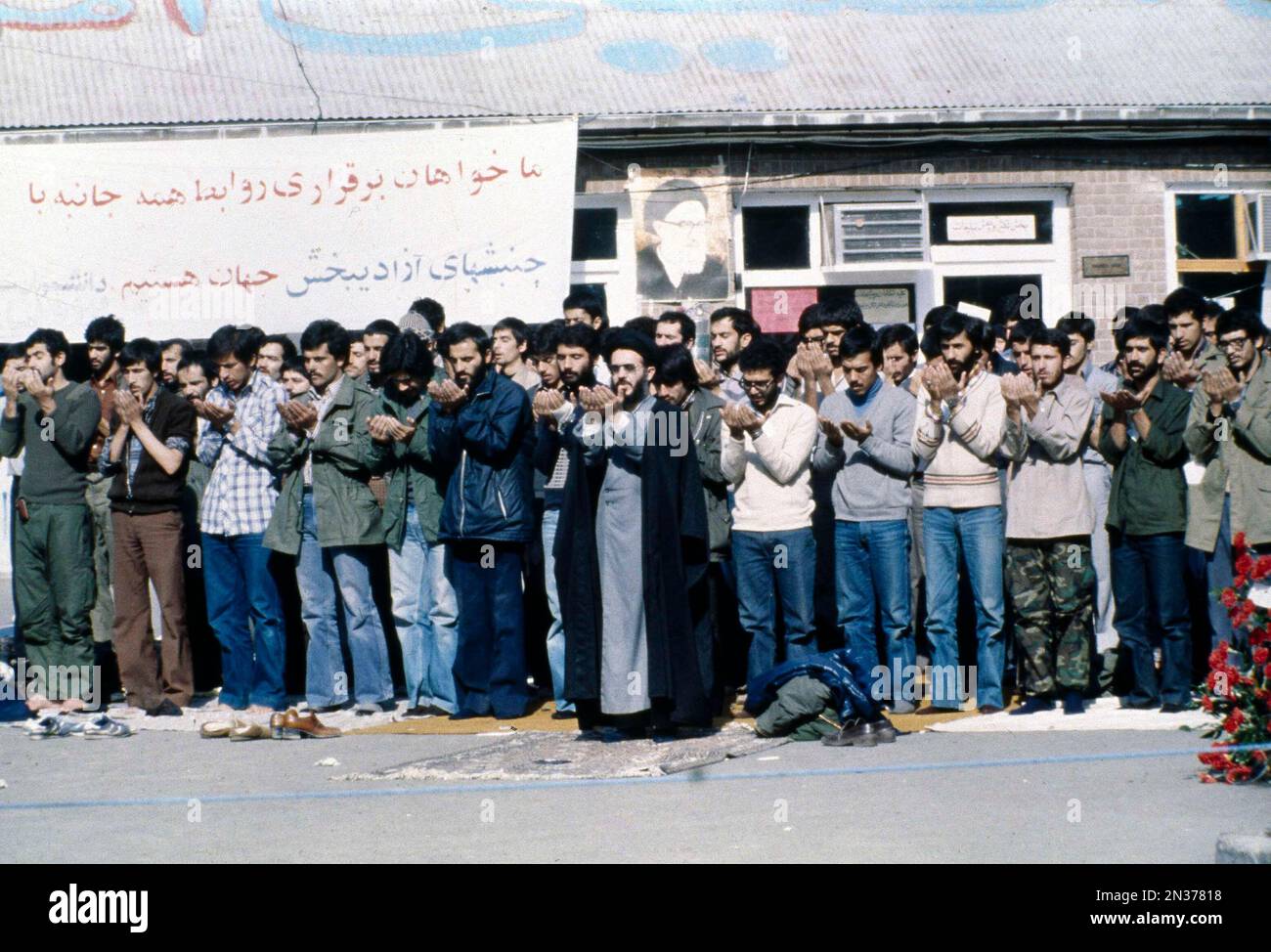 Iranian militia men pray outside the U.S. Embassy in Tehran, Iran, Nov ...