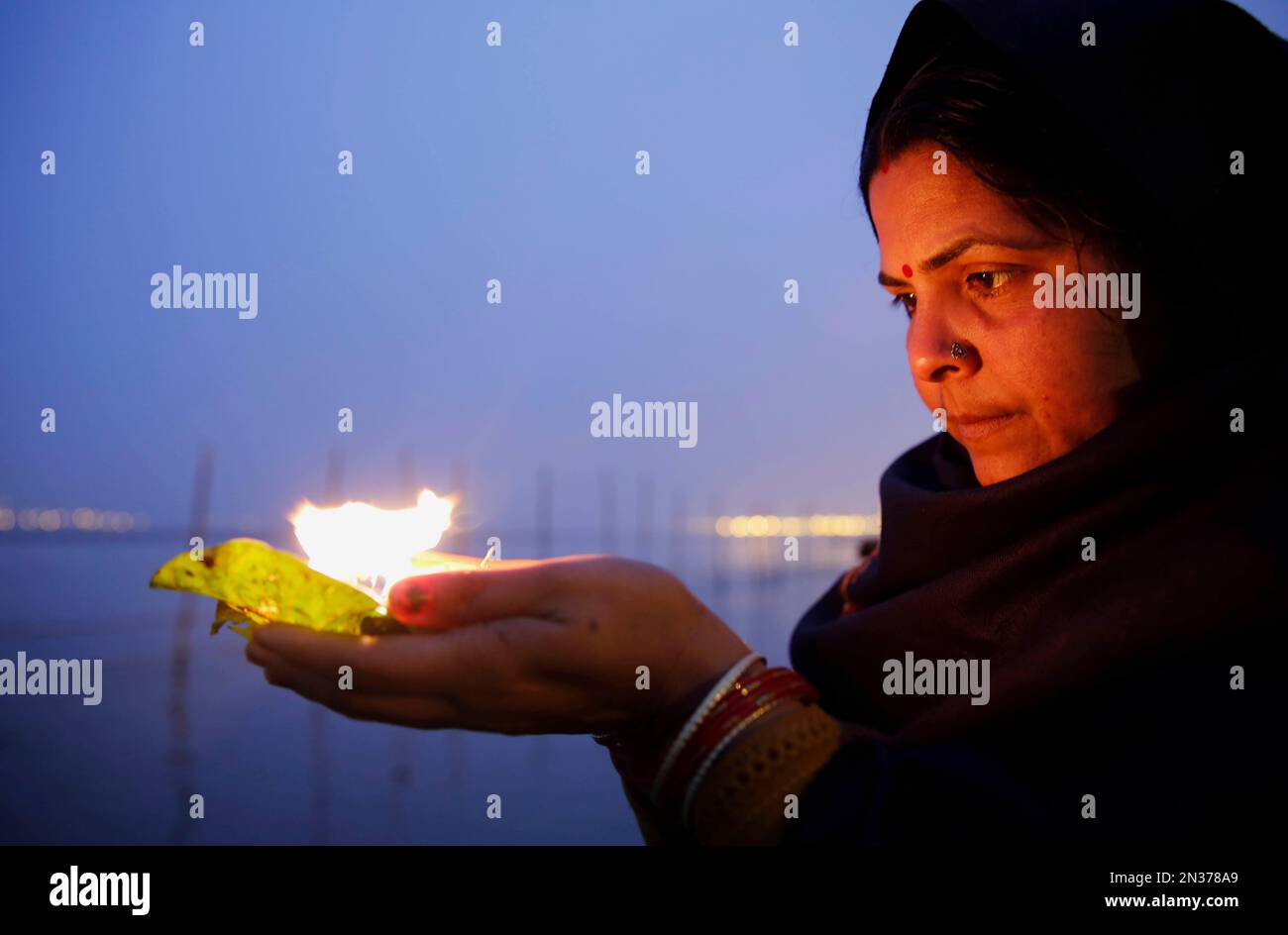 A Kalpavasi woman performs evening rituals after taking a holy dip at ...