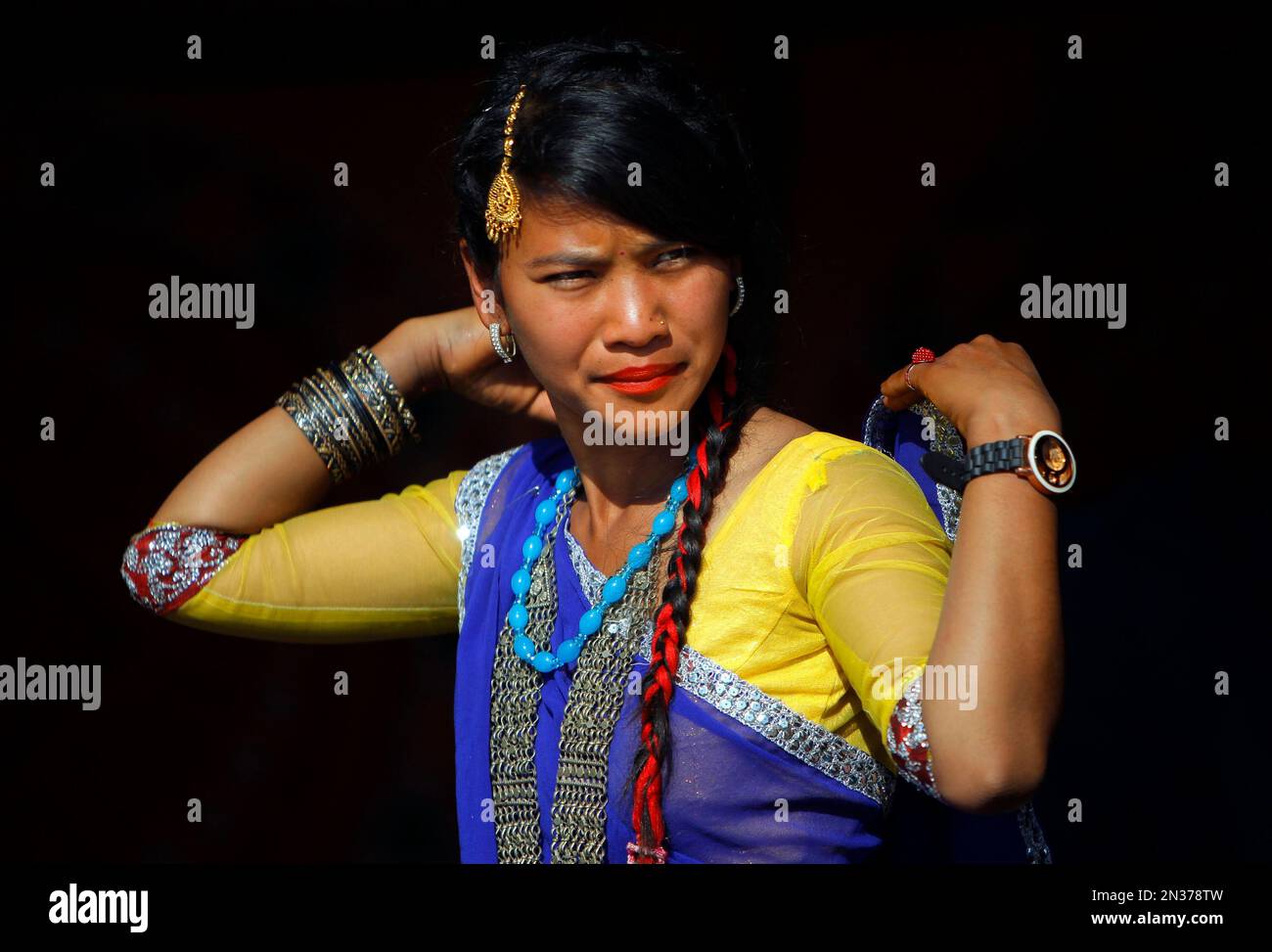A Nepalese Tharu ethnic community woman adjust the veil of her ...