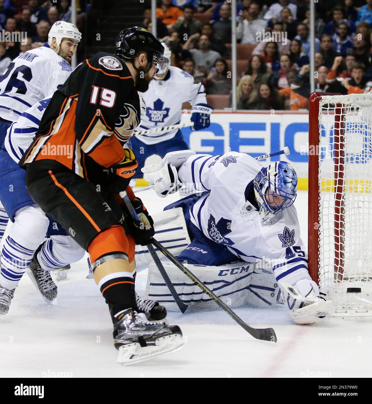 Toronto Maple Leafs goalie Jonathan Bernier, right, blocks a shot by ...